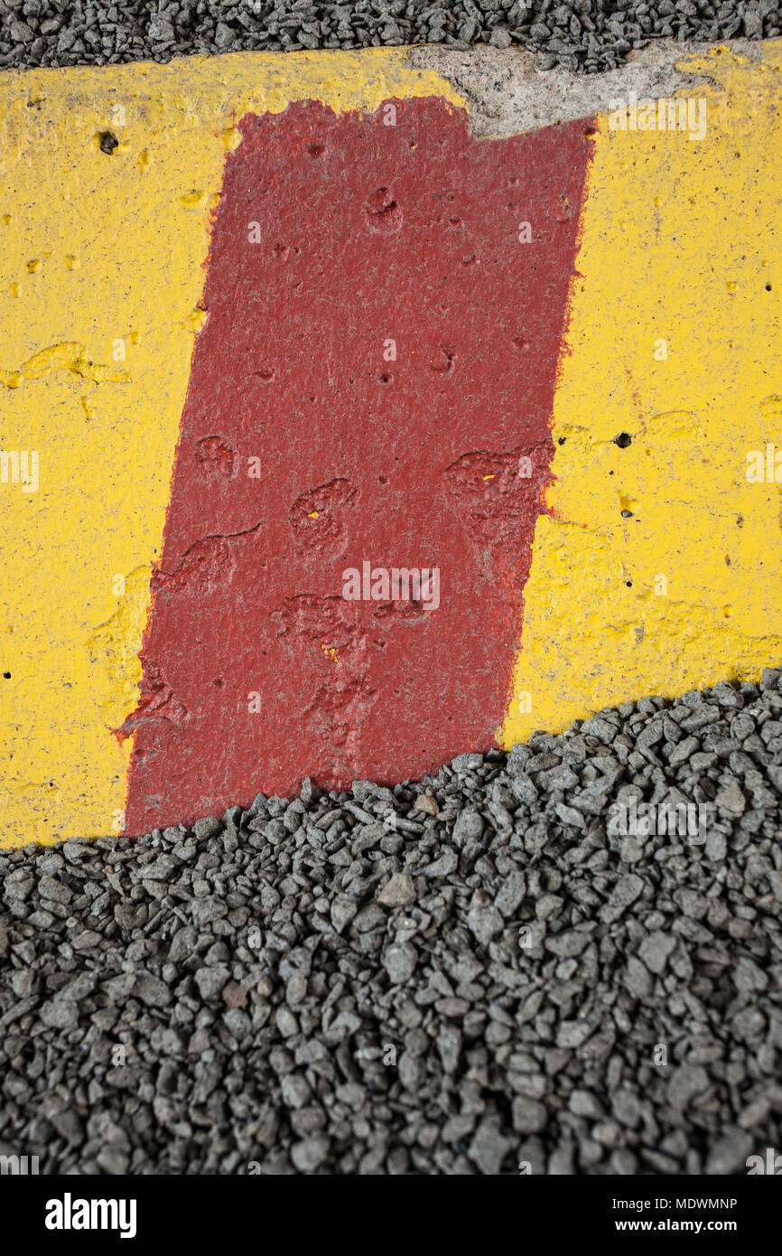 Worn concrete roadblock in gravel Stock Photo - Alamy