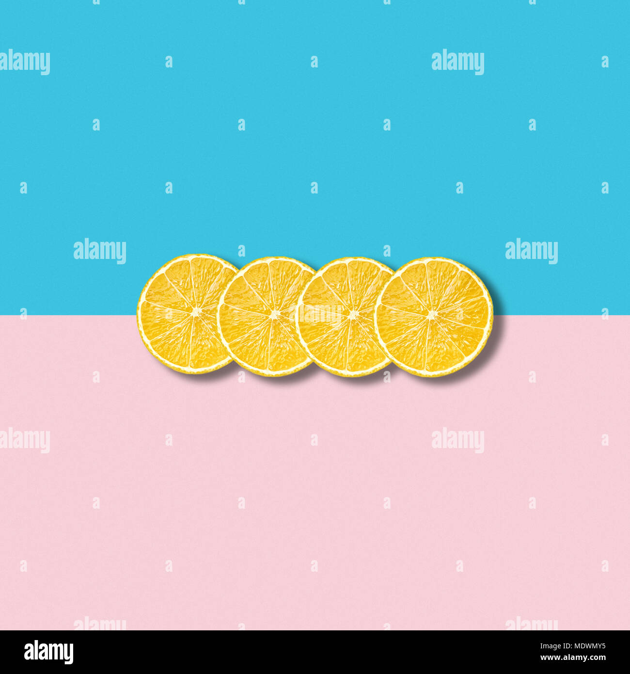 Minimal abstract illustration with group of lemon slices on pastel pink ...