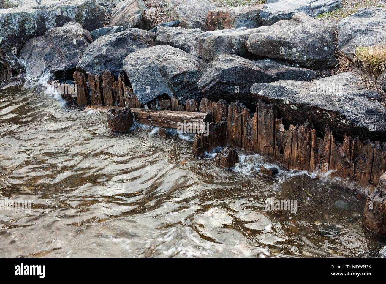Old worn wooden structure in water Stock Photo - Alamy