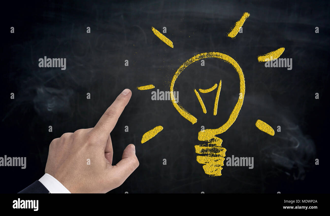 Hand pointing on lightbulb concept Stock Photo - Alamy