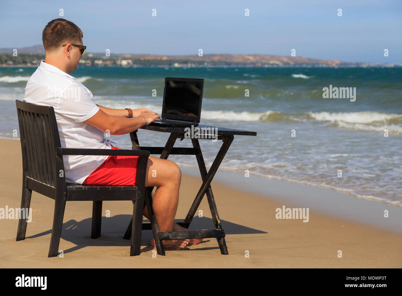 Business Man Working on Tropical Beach Stock Photo - Alamy