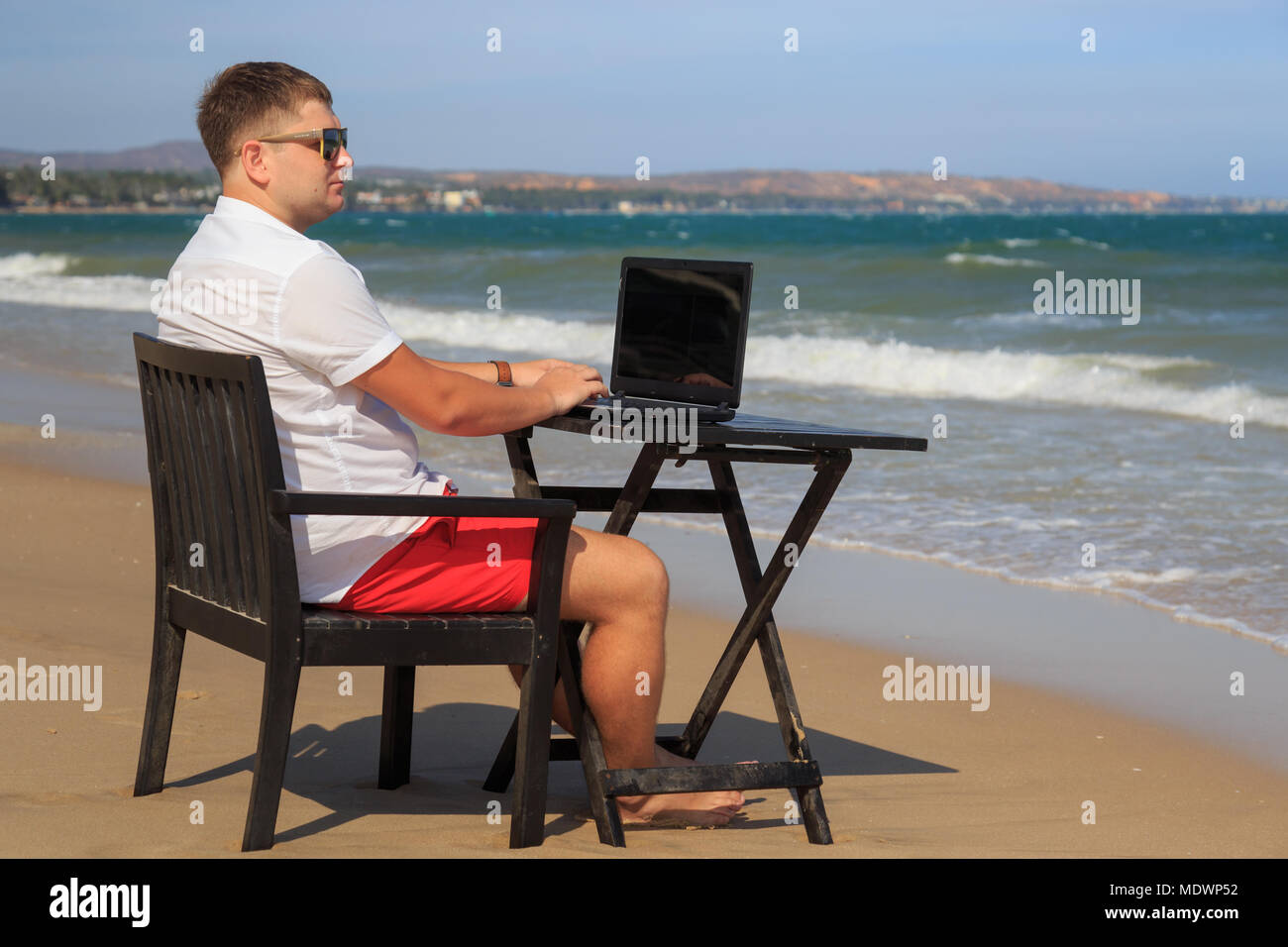Business Man Working on Tropical Beach Stock Photo - Alamy