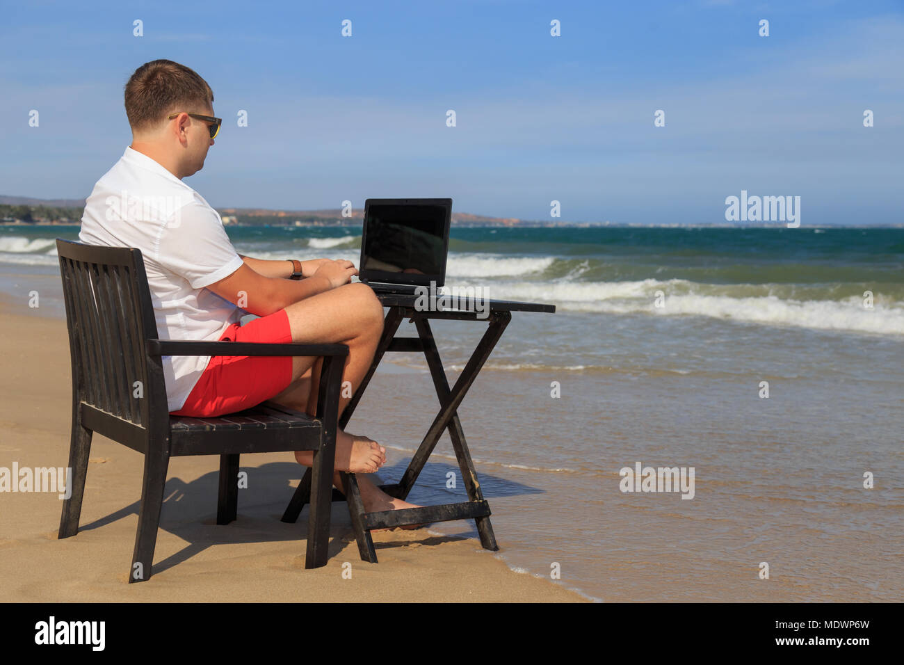 Business Man Working on Tropical Beach Stock Photo - Alamy
