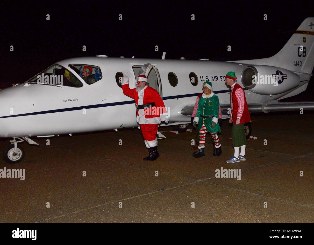 Santa Claus and three of his elves exit a T-1A Jayhawk, piloted by ...