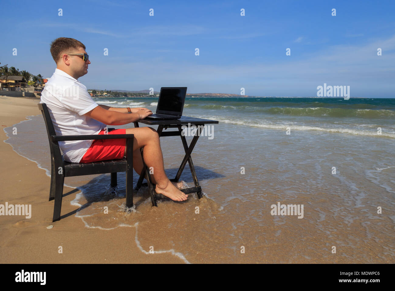 Business Man Working on Tropical Beach Stock Photo - Alamy