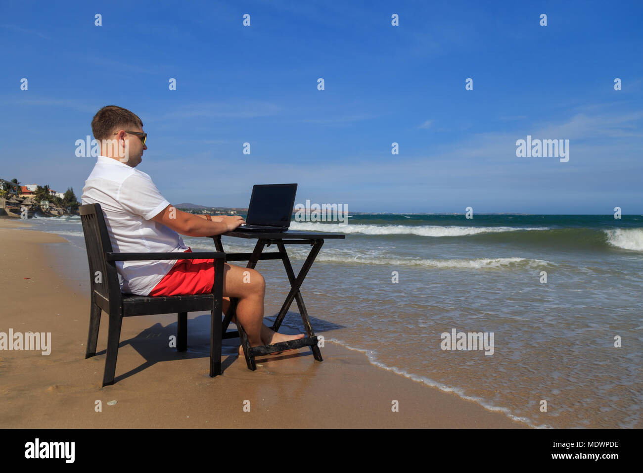 Business Man Working on Tropical Beach Stock Photo - Alamy