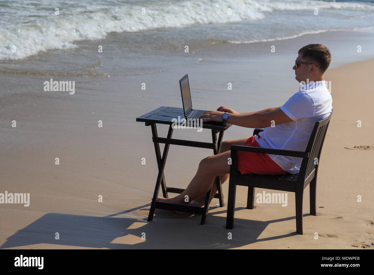 Business Man Working on Tropical Beach Stock Photo - Alamy