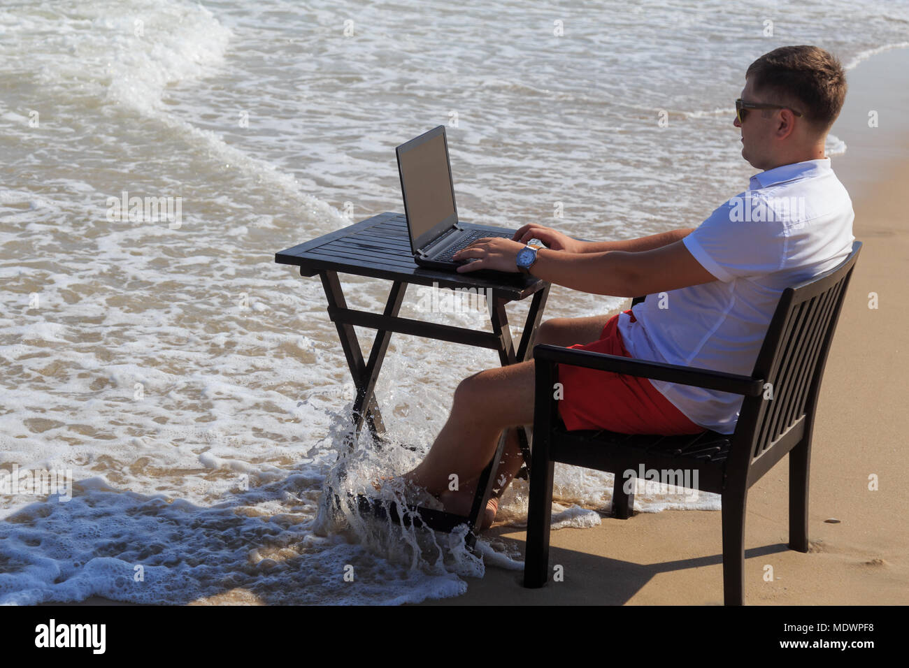 Business Man Working on Tropical Beach Stock Photo - Alamy