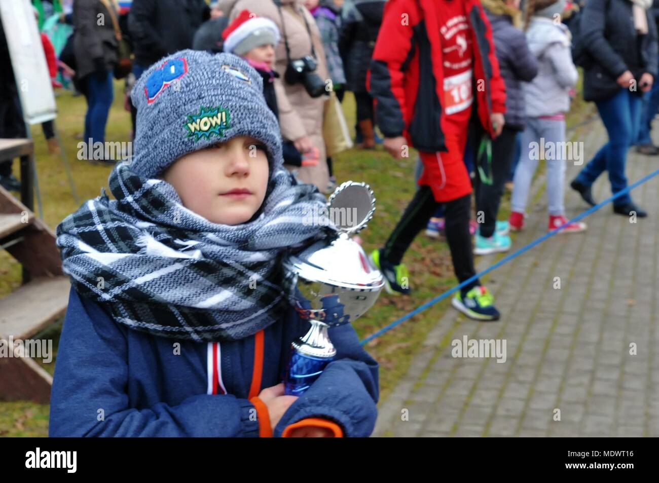 A little Polish girl embraces her winner’s trophy after completing her ...