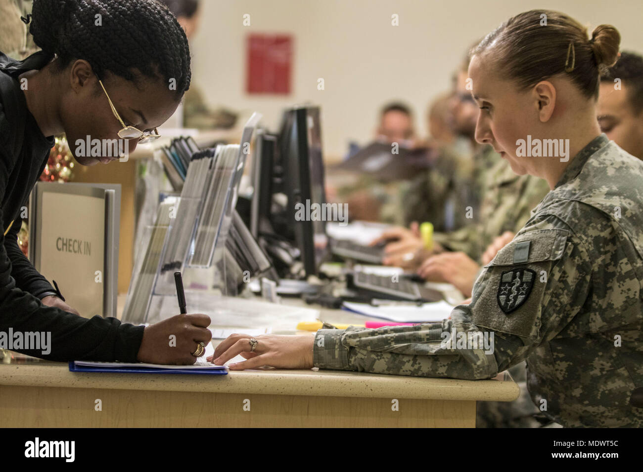 Spc. Rebekah Pletcher, 7250th Medical Support Unit, procesess a soldier ...