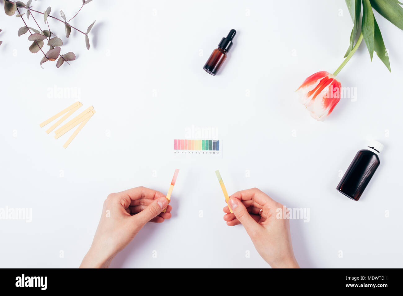 Woman check cosmetics pH level by using litmus paper and rating scale ...