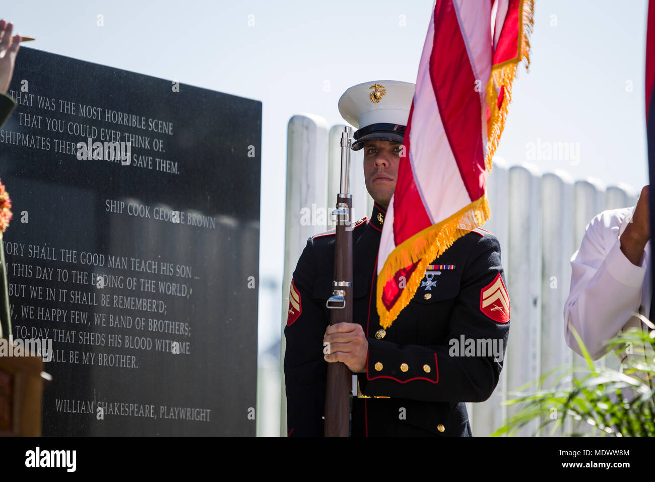 A Marine, part of the Joint Service Color Guard, stands at attention ...