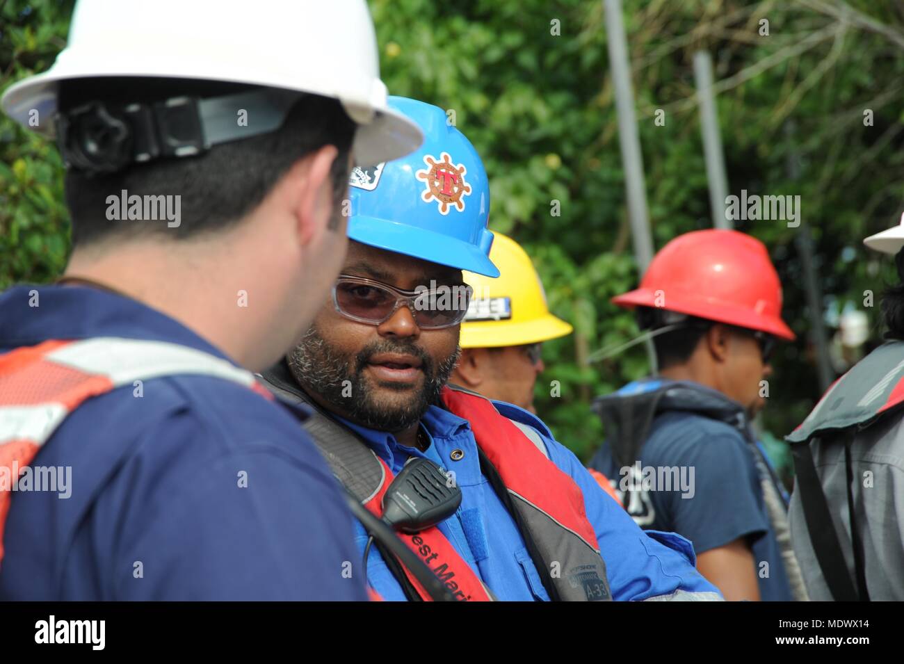 Local crewman Hector Rodriquez talks to Coast Guard Lt. Timothy Brown ...