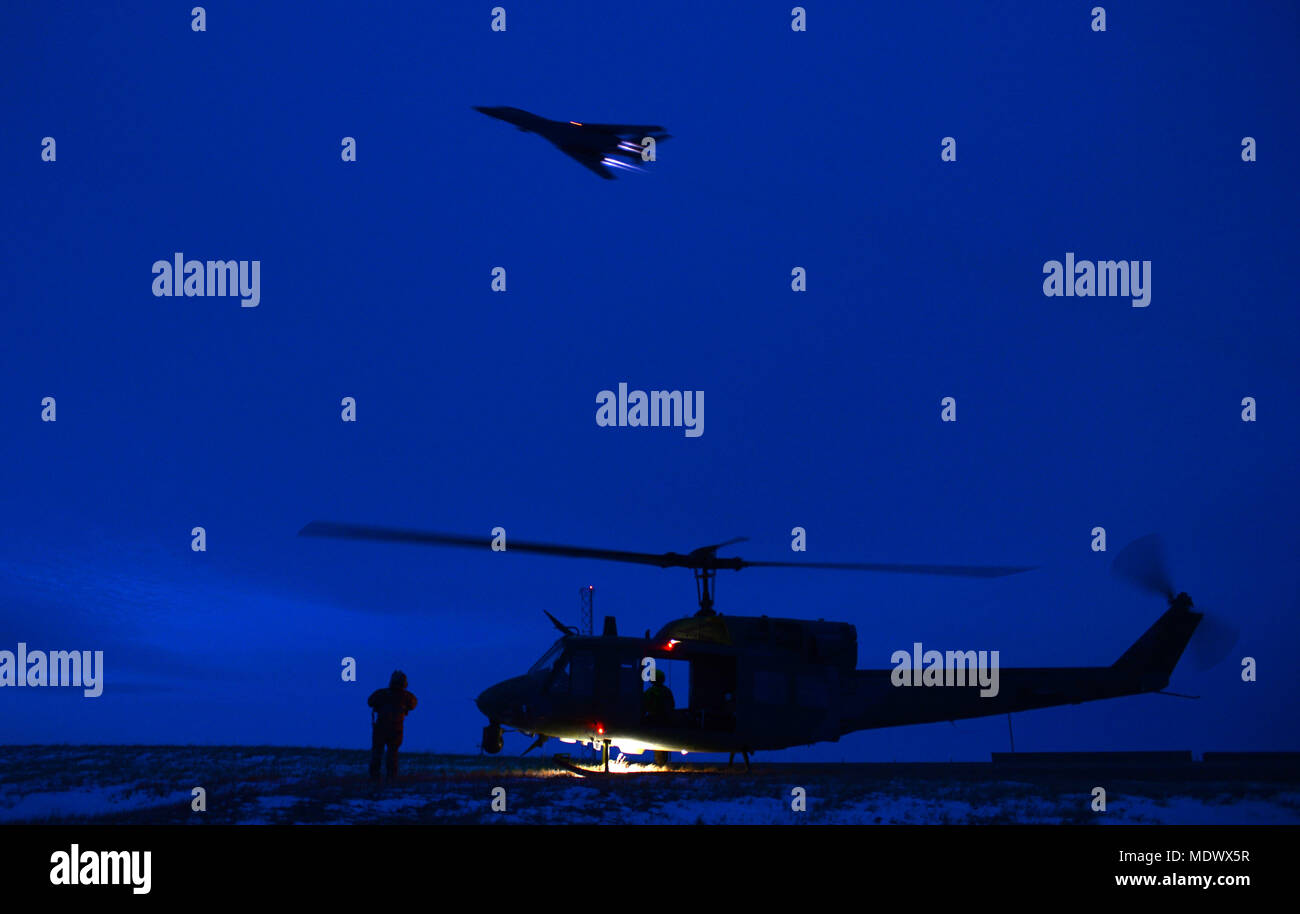 A B-1 bomber from Ellsworth Air Force Base, S.D., flies over a UH-1N ...