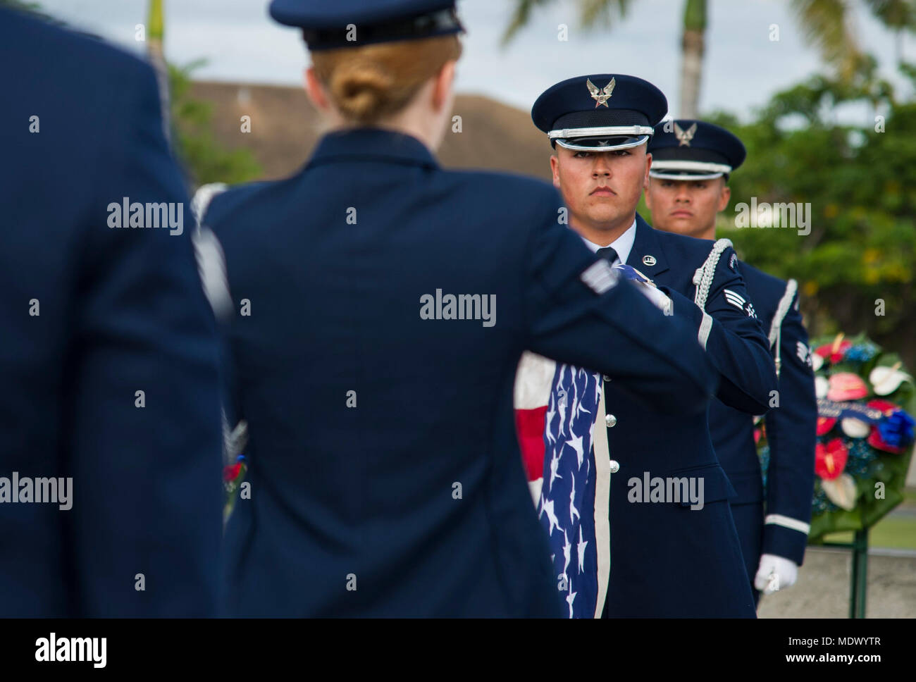 Members of the Hickam Honor Guard fold the U.S. flag during a retreat ...