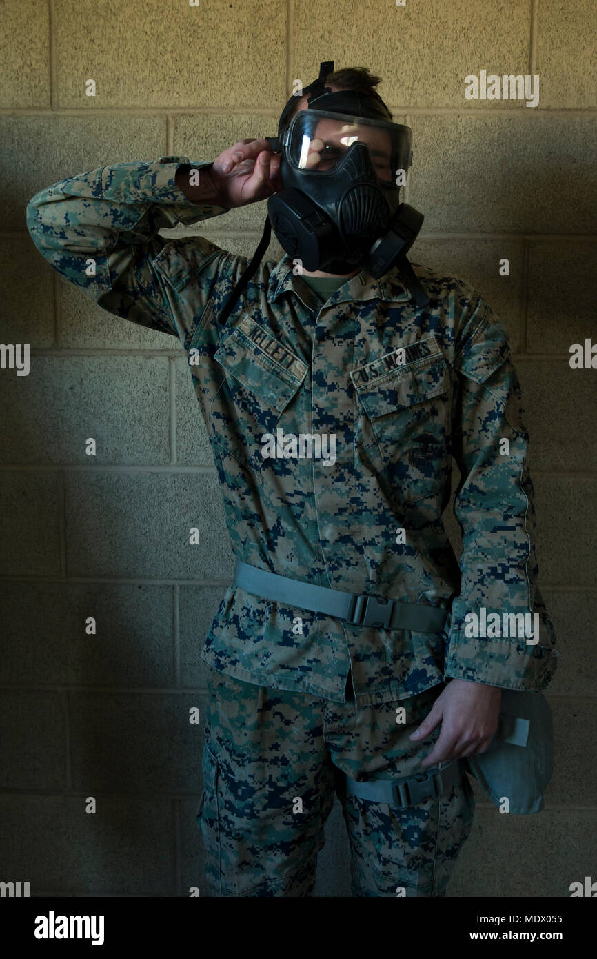 A Marine with Headquarters and Support Battalion breaks the seal of his ...