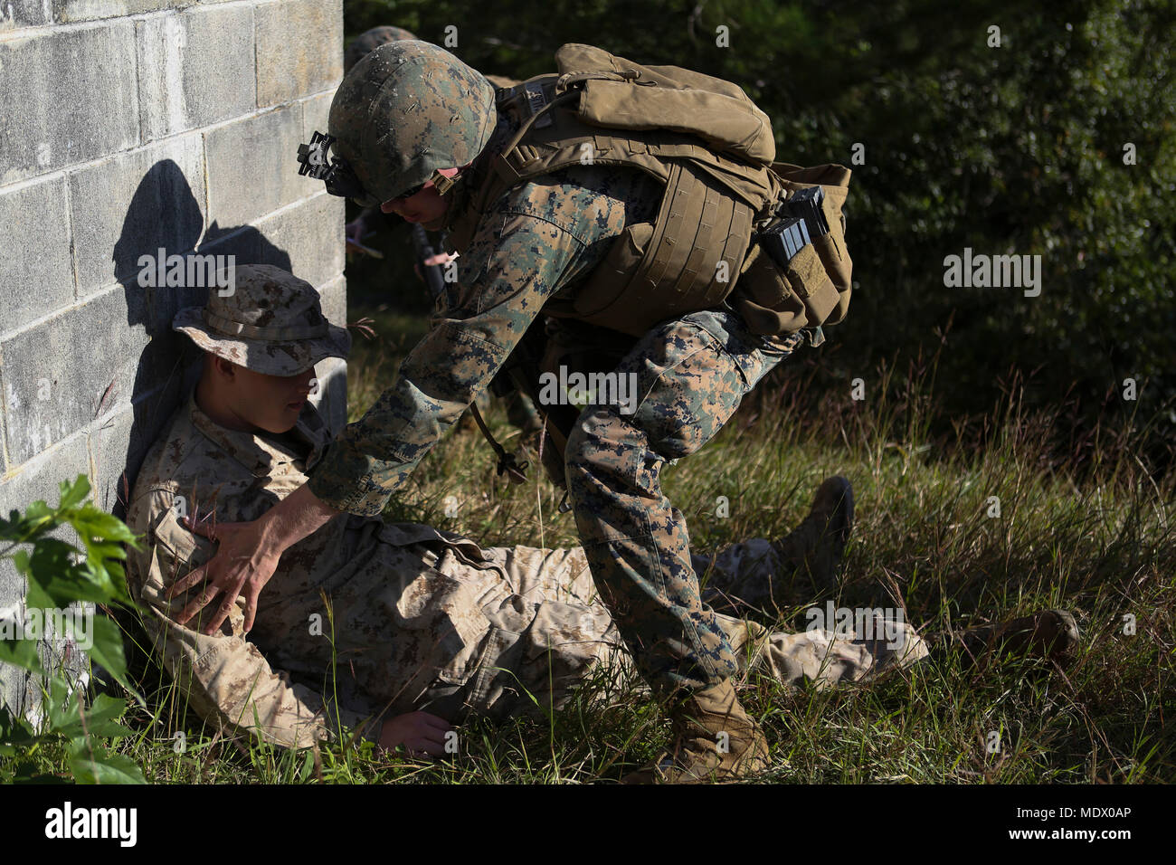 A Marine with 3rd Marine Logistics Group Headquarters searches a ...