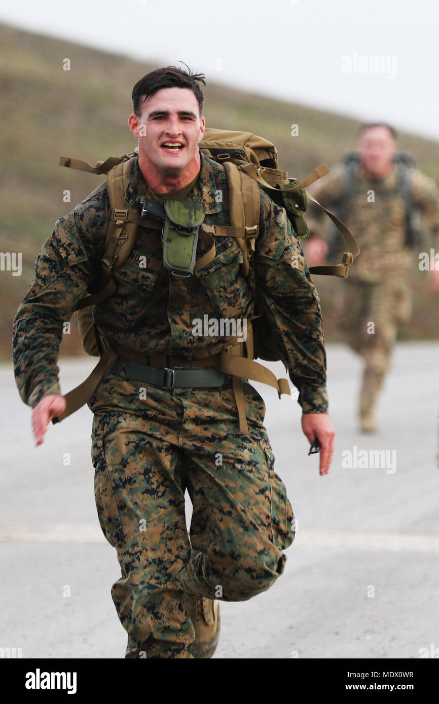 A KFOR U.S. Marine sprints toward the finish line during ruck march ...