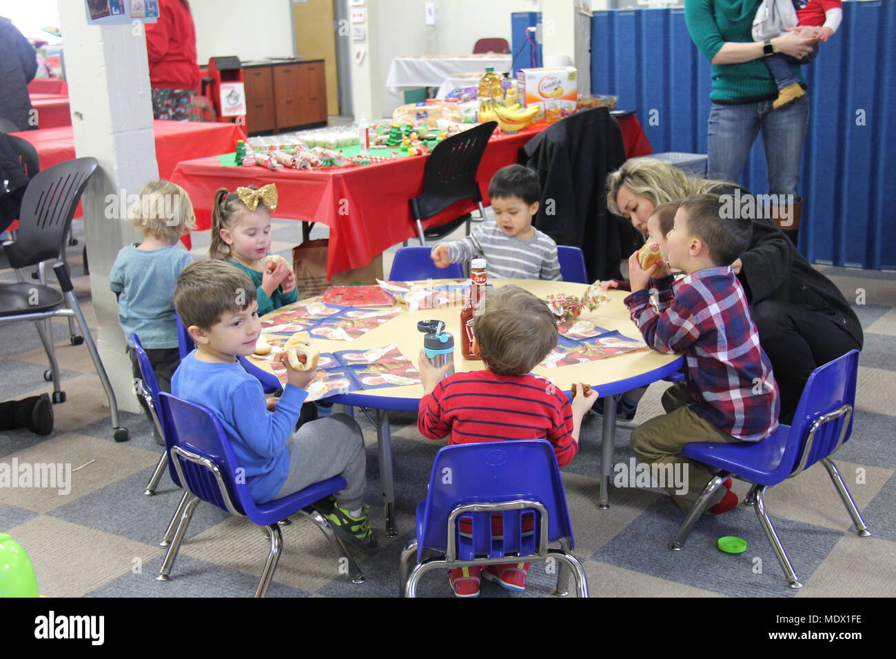 Fort McCoy Family members have a snack during the Dec. 12, 2017 ...