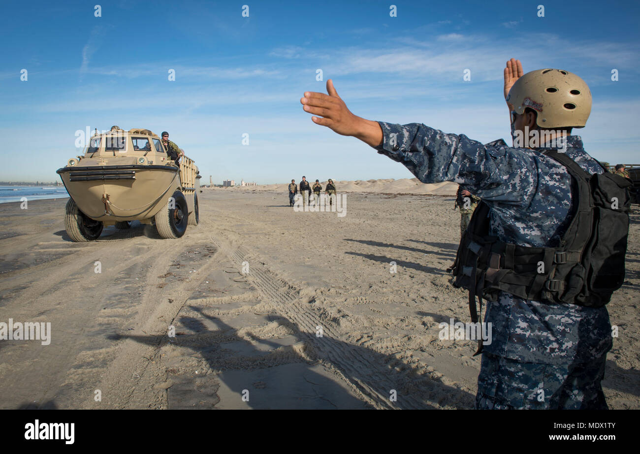A Sailor assigned to Beachmaster Unit One (BMU-1) directs a Light ...
