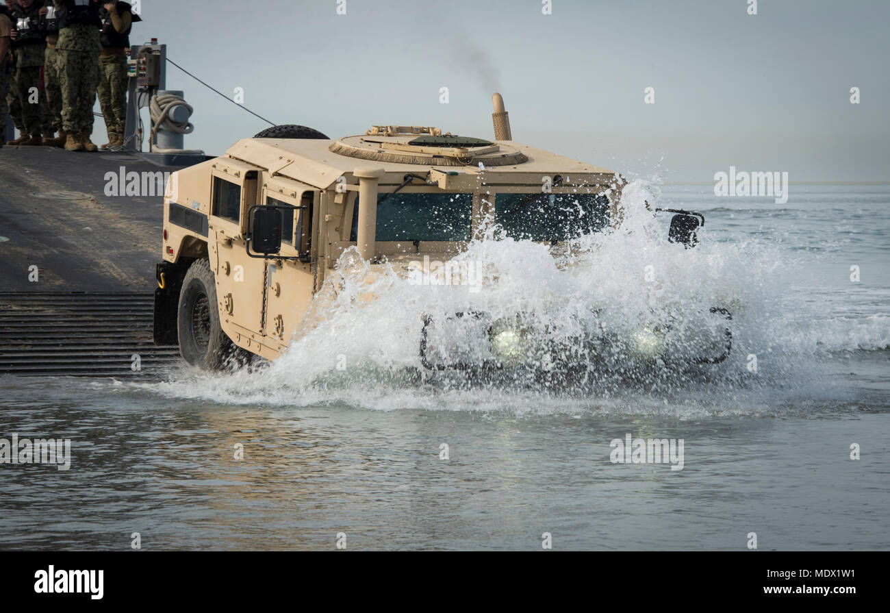 Seabees assigned to Amphibious Construction Battalion One (ACB-1) drive ...