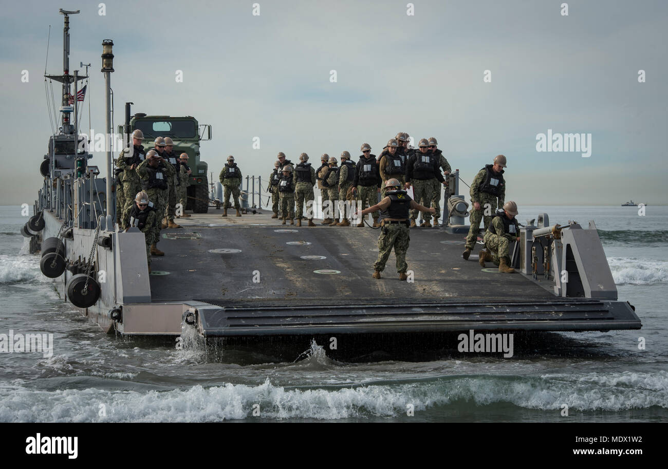 Seabees assigned to Amphibious Construction Battalion One (ACB-1) raise ...