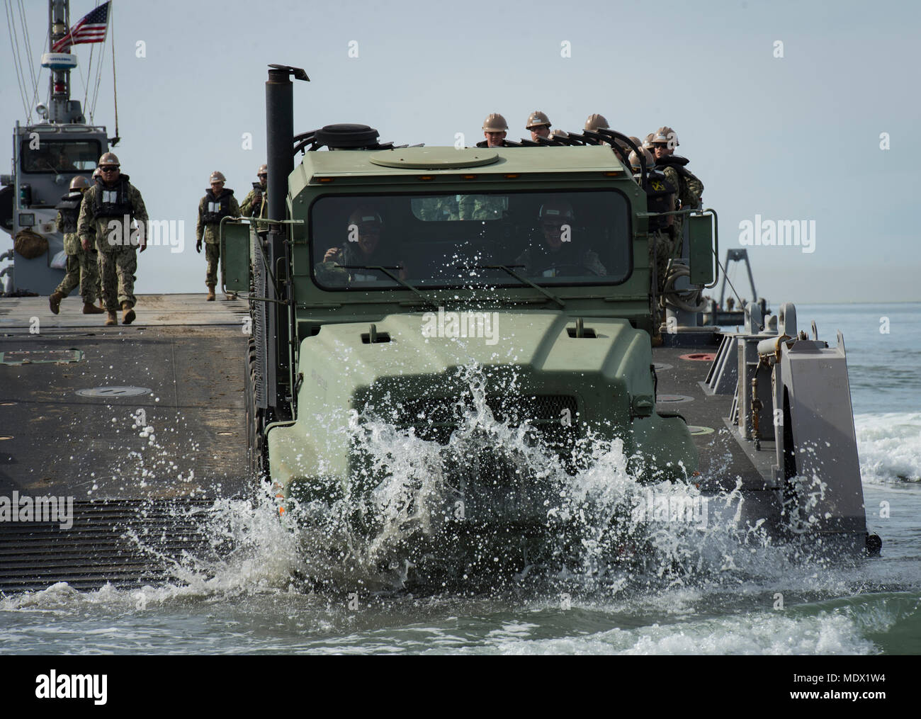 Seabees assigned to Amphibious Construction Battalion One (ACB-1) bring ...