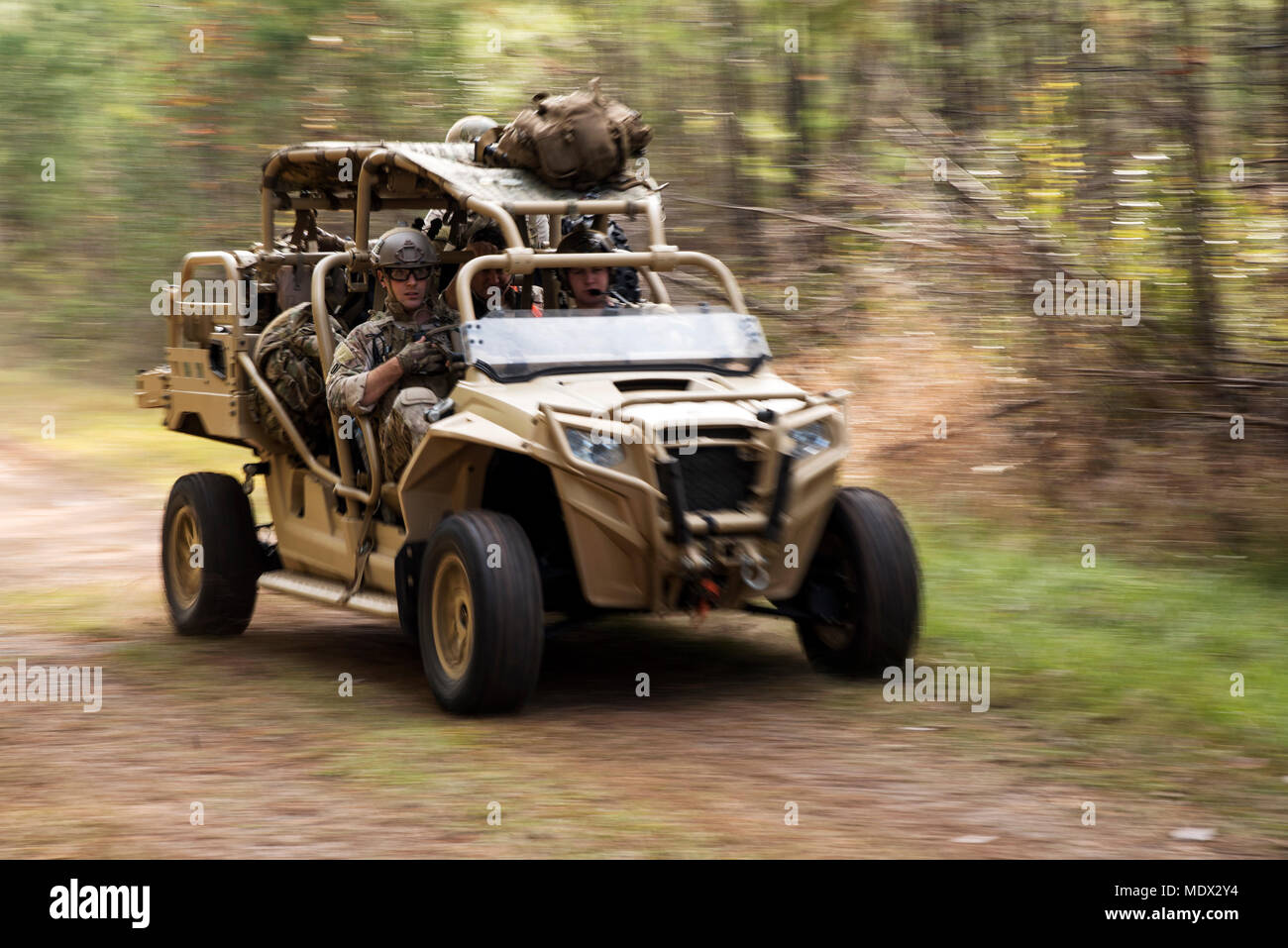 Airmen from the 38th Rescue Squadron (RQS) drive a military RZR all ...