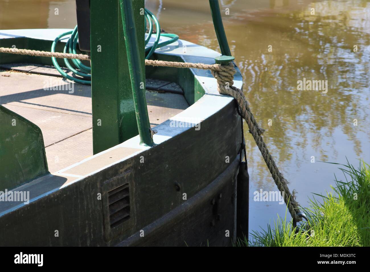 Canal boat / barge moored at side of canal by rope and hooks Stock ...