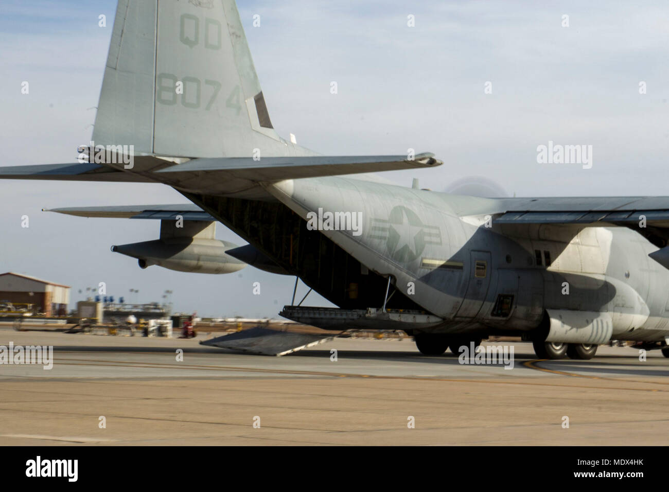 A pallet is released from a moving U.S. Marine Corps KC-130J Hercules ...