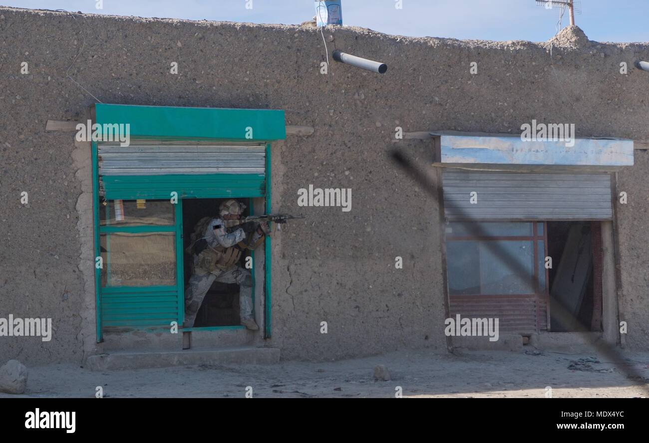 An Afghan Special Police Unit operator engages an insurgent from a ...