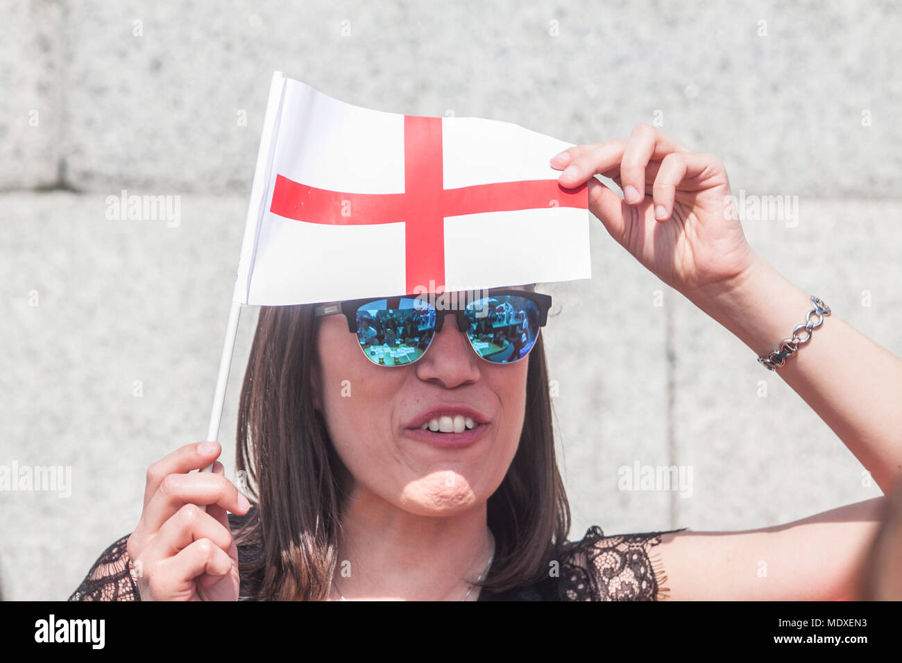 London UK. 21st April 2018. A woman shields her head from the sun with ...