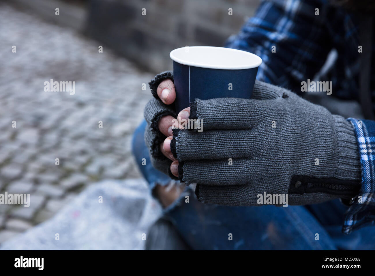 Homeless holding cup hi-res stock photography and images - Alamy