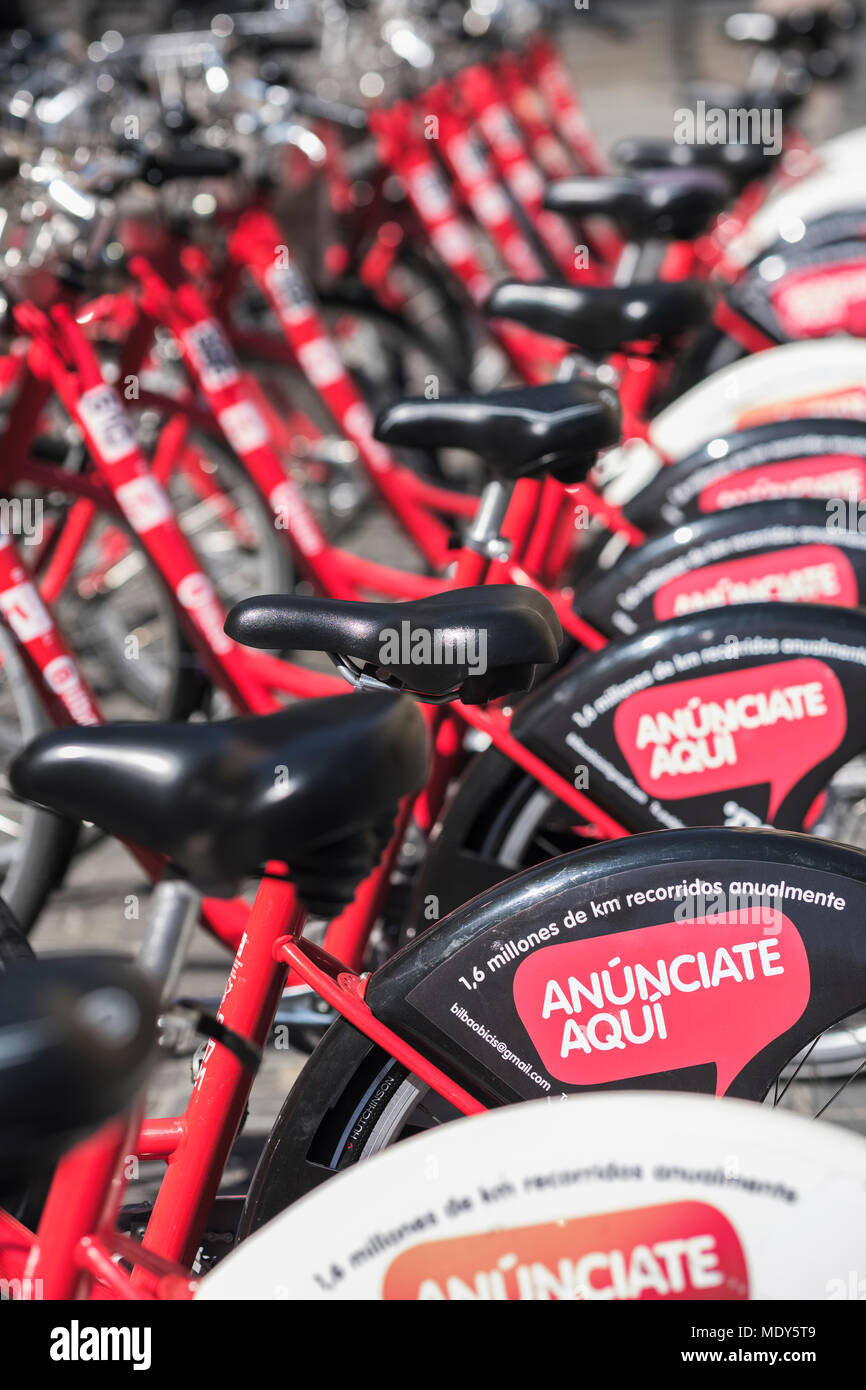 Electric battery powered city bicycles for hire, parked in a row ...
