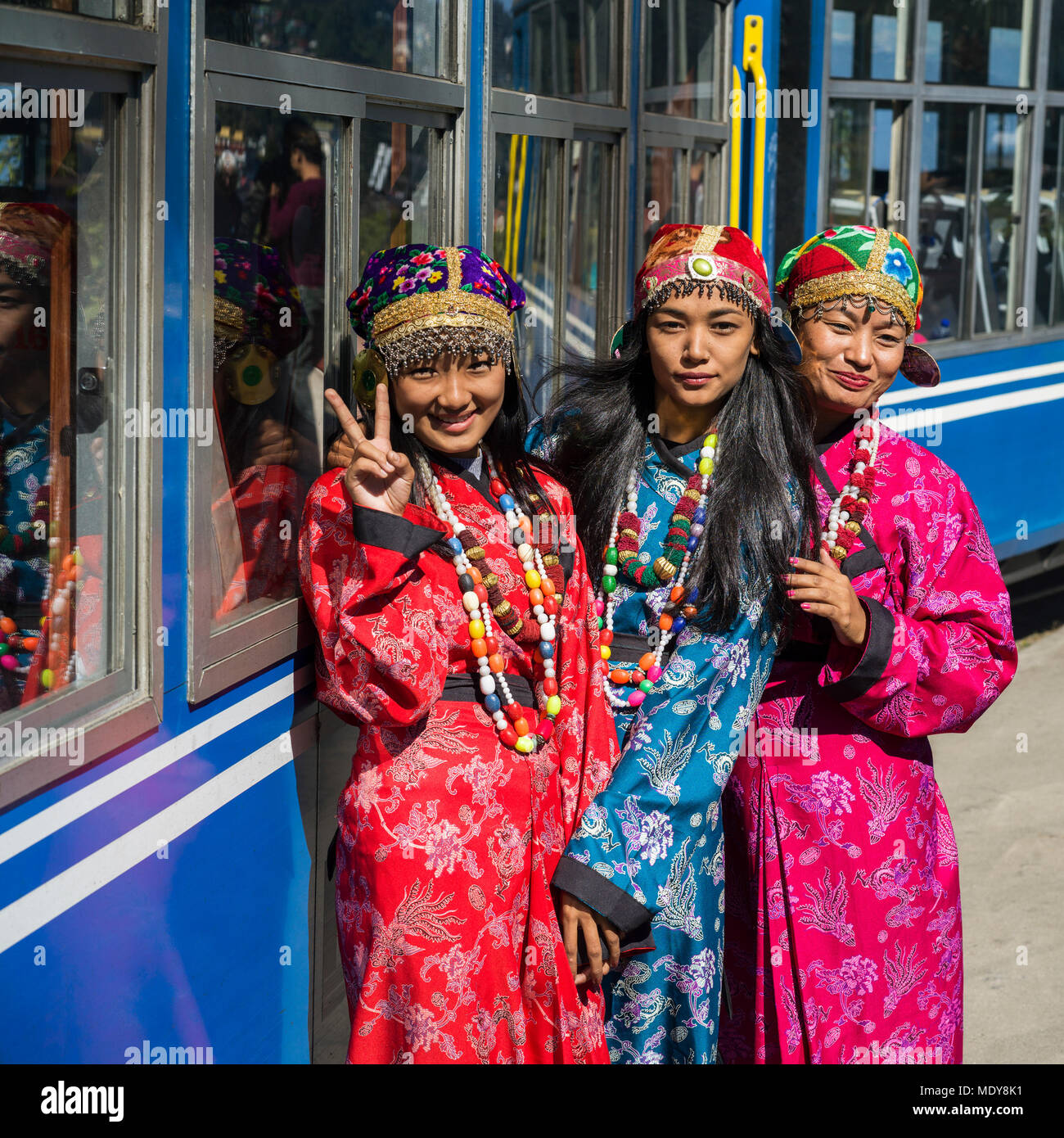 Three women wearing kimonos pose outside the Darjeeling Toy Train ...