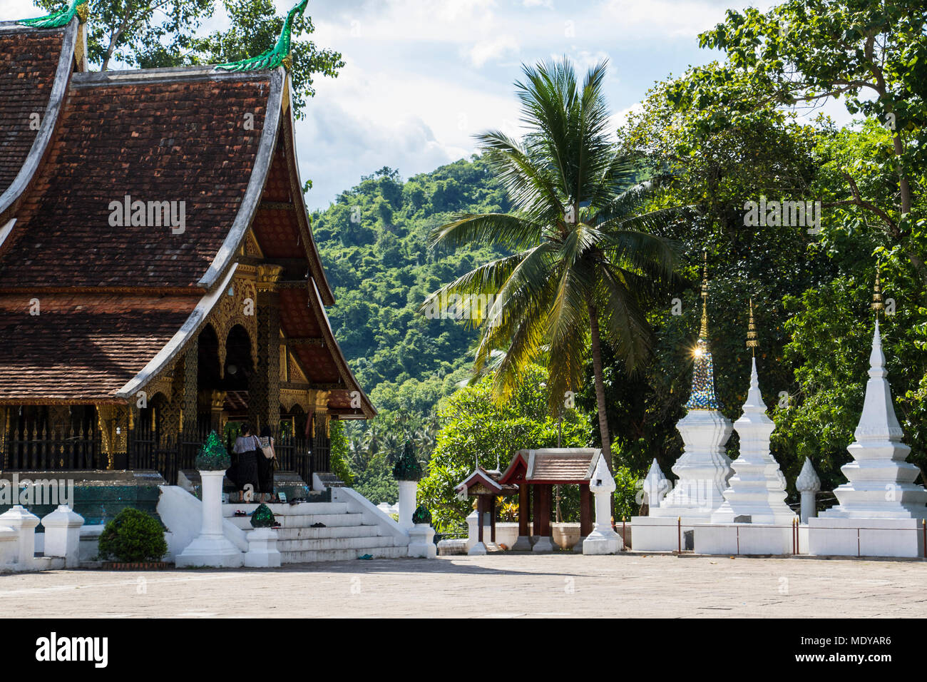 Sim (congregation hall) and stupas of Wat Xieng Thong; Luang Prabang ...