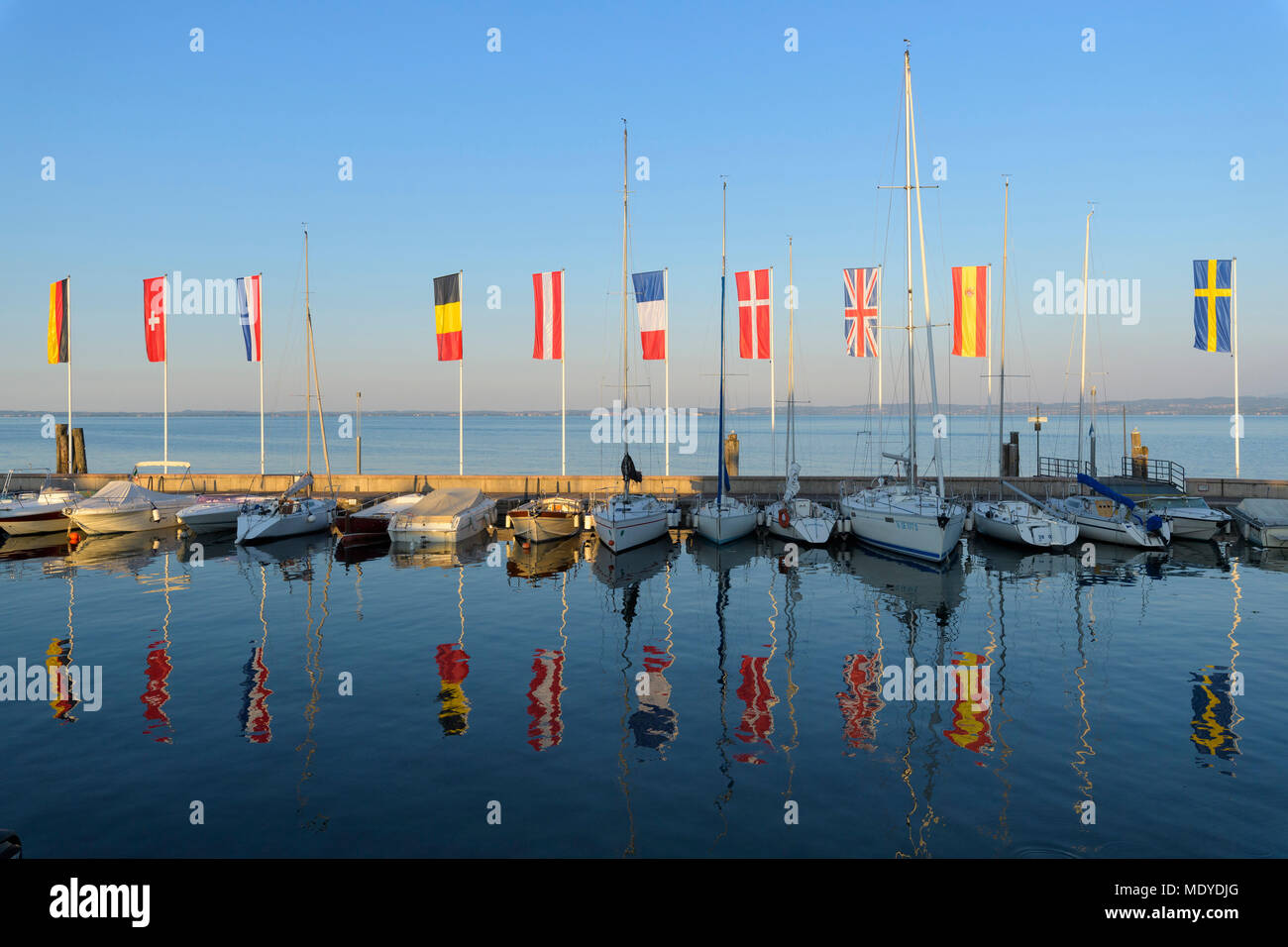 Row of boats and colorful European flags in the harbor marina on Lake ...