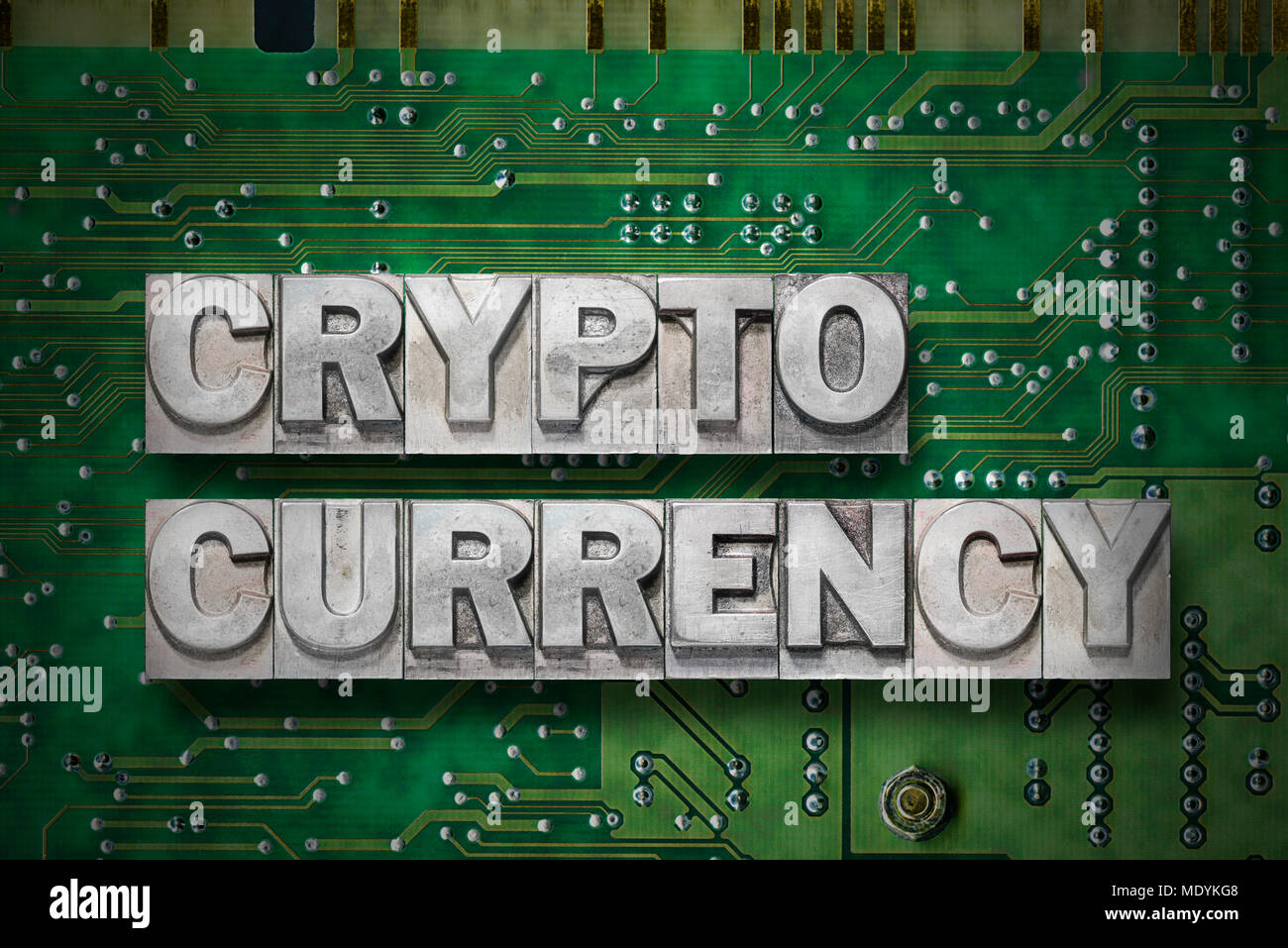 crypto currency phrase made from metallic letterpress blocks on the pc ...