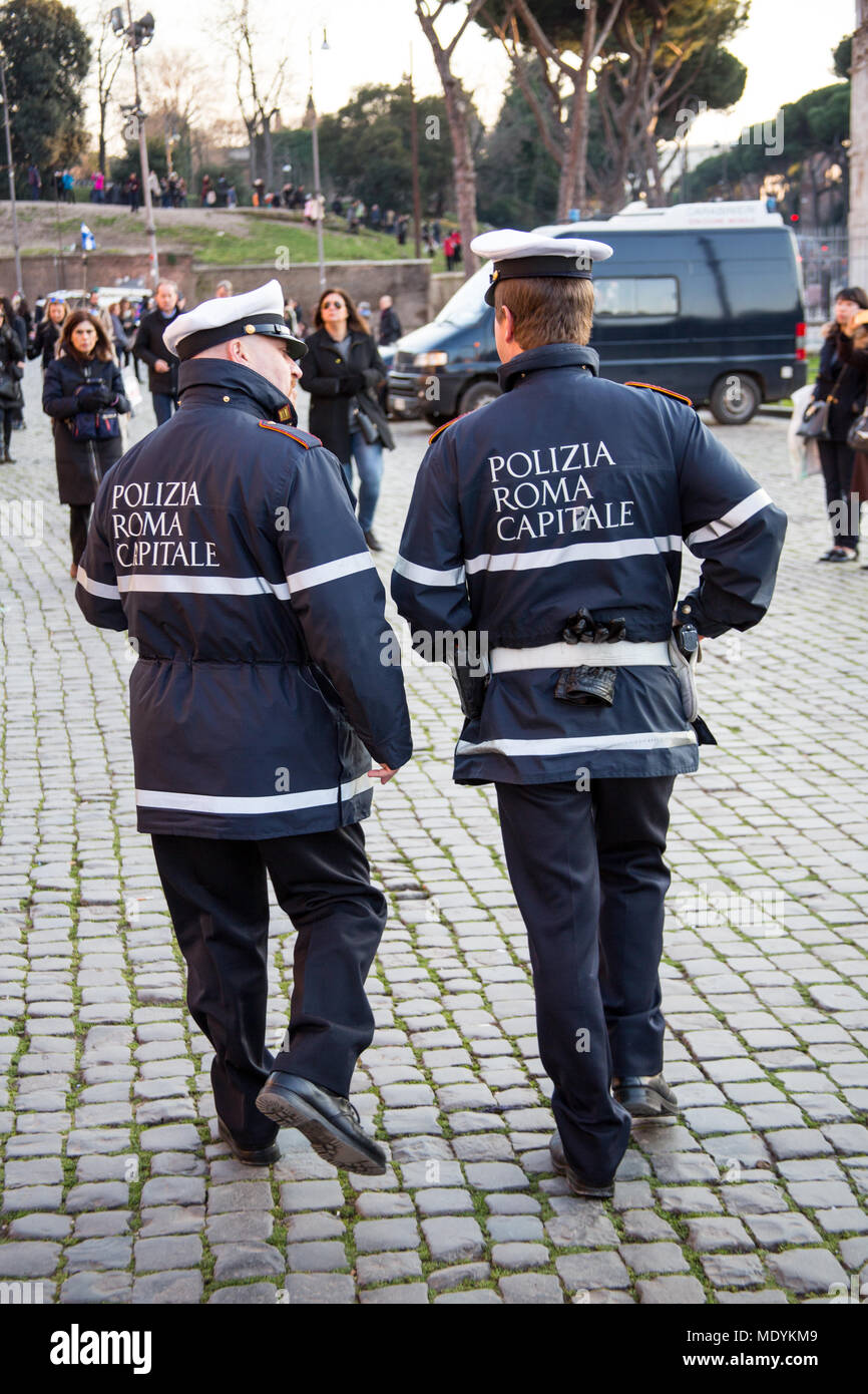 On a cloudy day two police officers make their rounds at the Colosseum ...