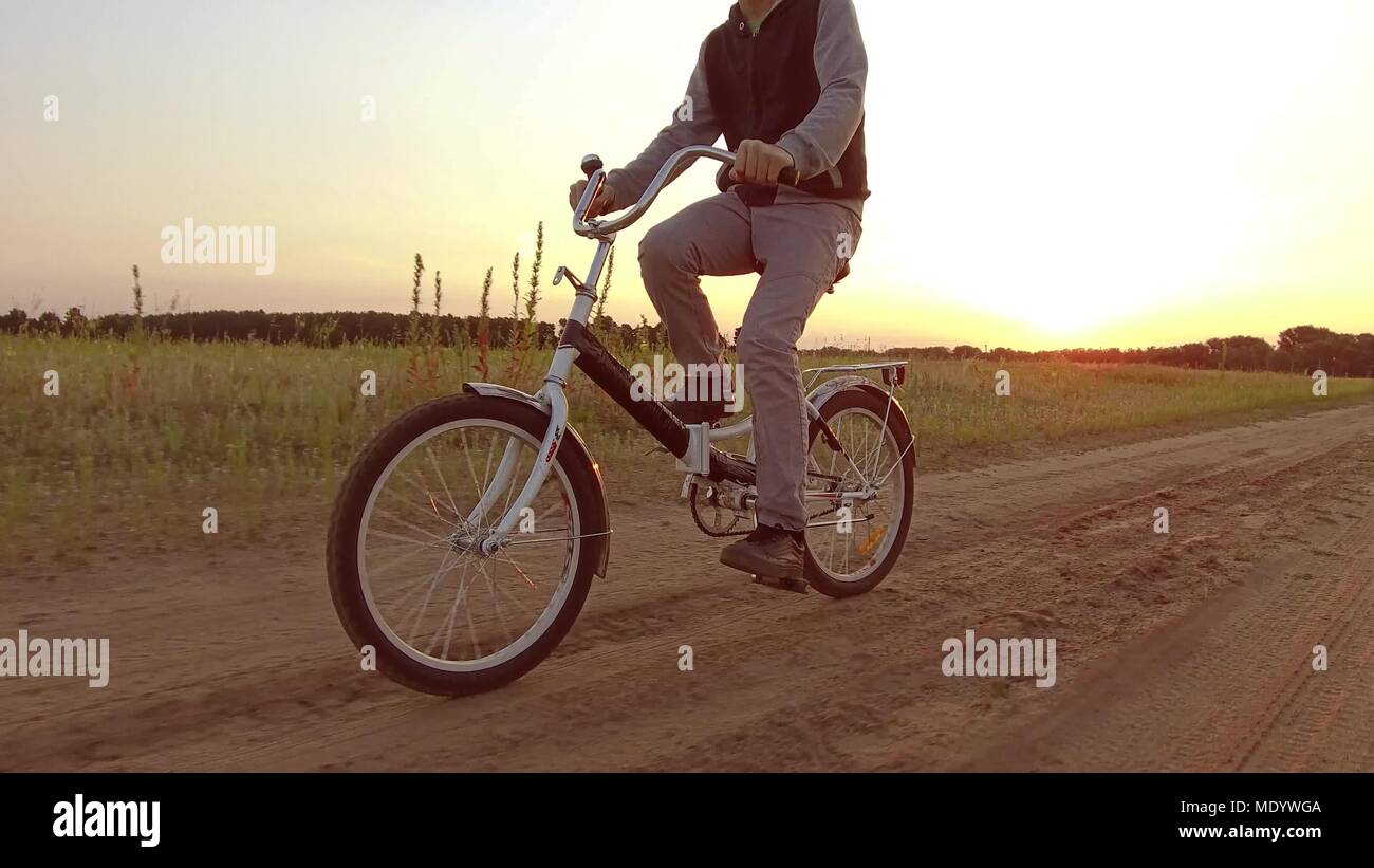 Boy teenager riding a bicycle. Boy teenager riding a bicycle goes to ...