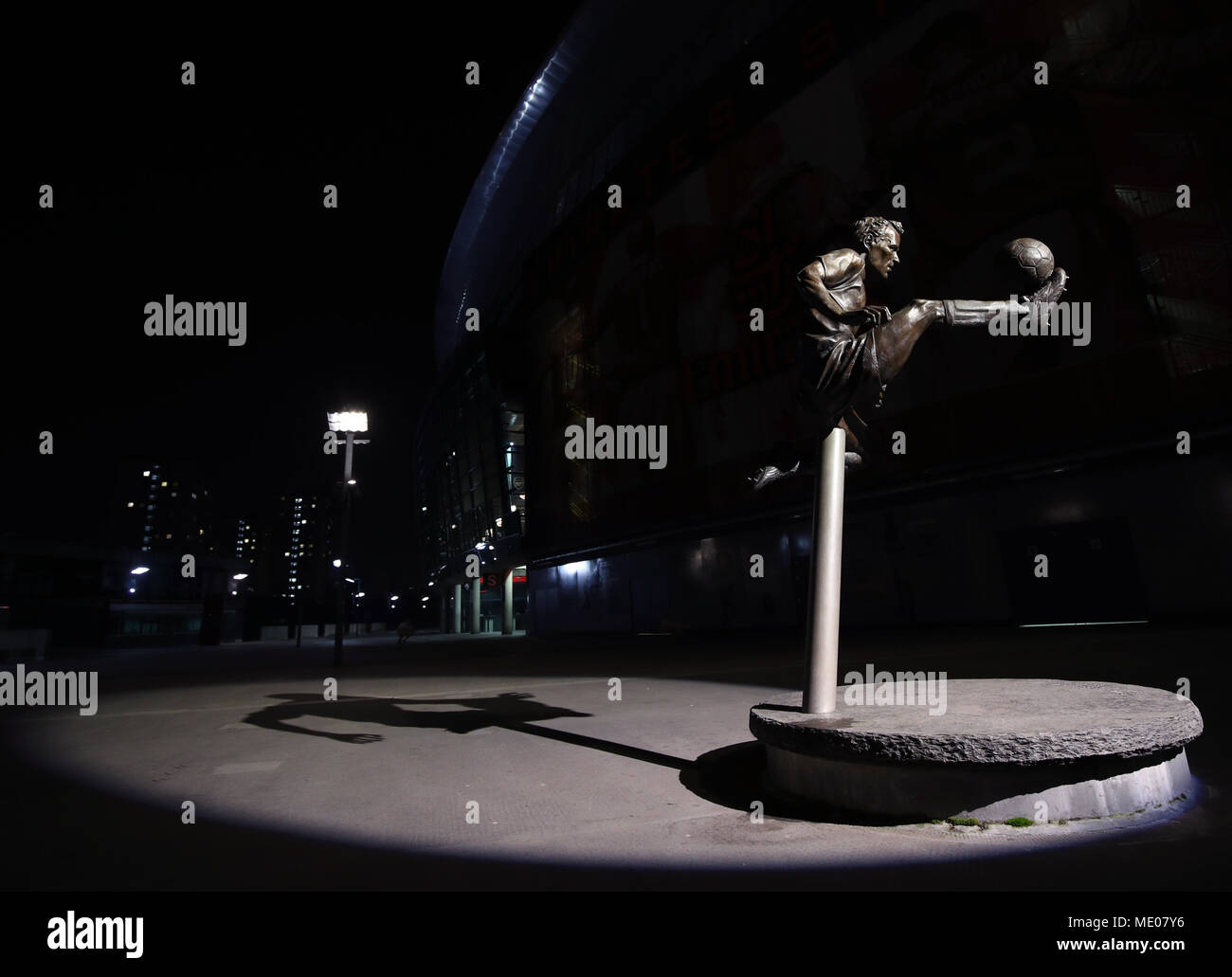 The Dennis Bergkamp statue lit up outside the Emirates Stadium, London ...