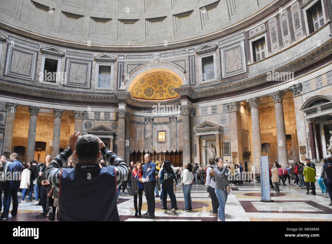 Tourists taking photos inside the Pantheon. The Pantheon is a former ...