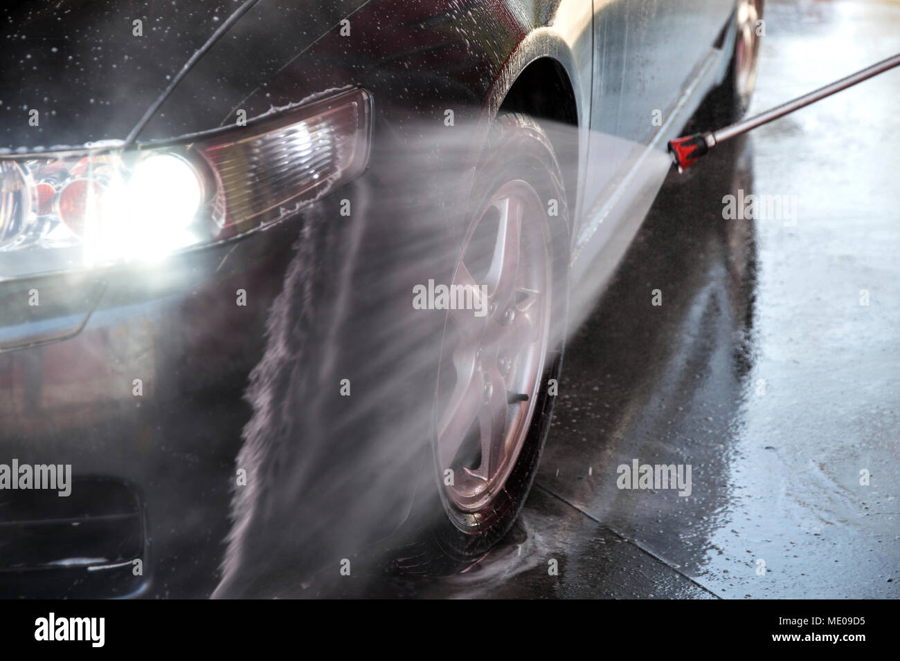 washing machine jet soap dispenser aimed at the headlight, closeup ...