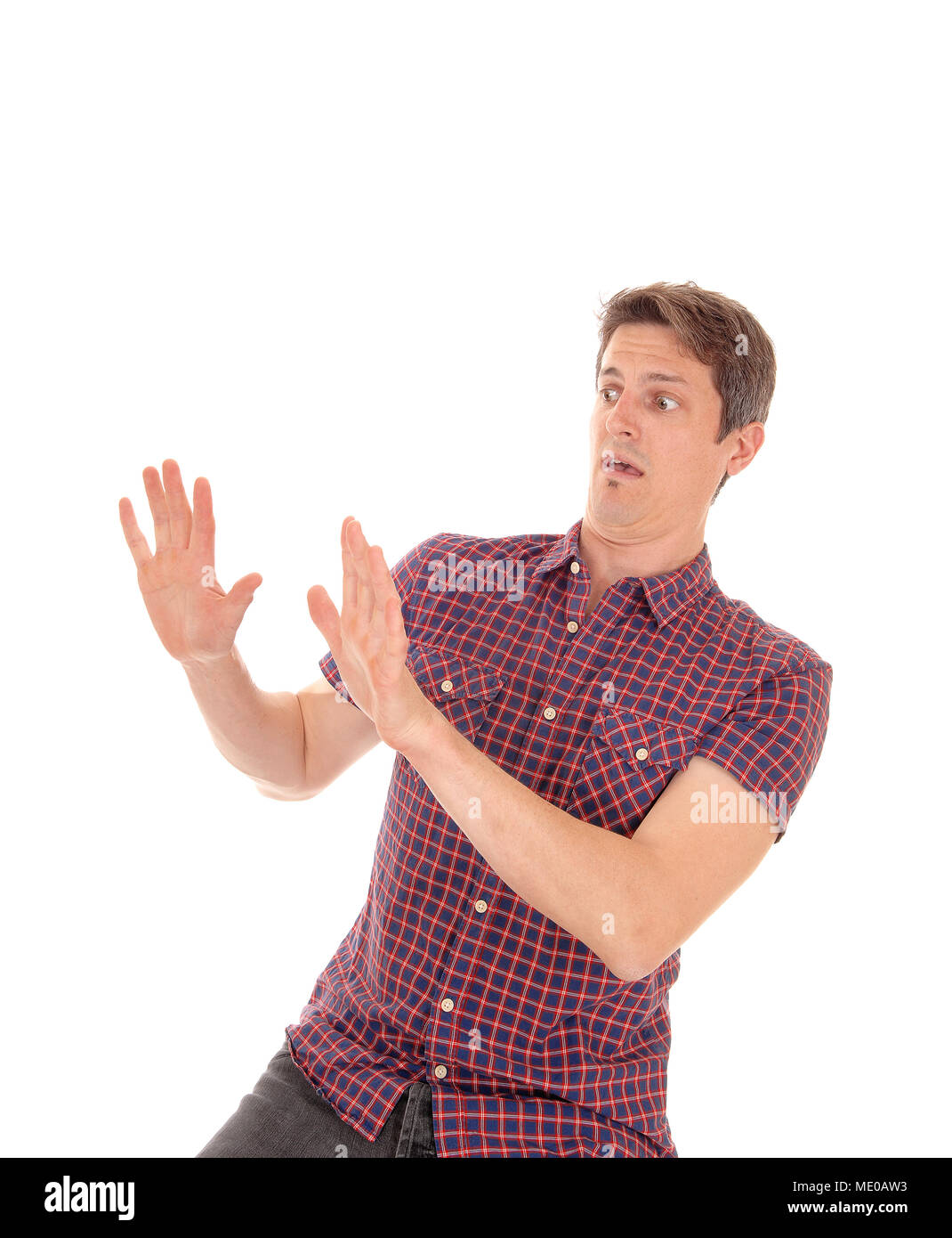 A young man holding his hands up telling every man do not come closer ...