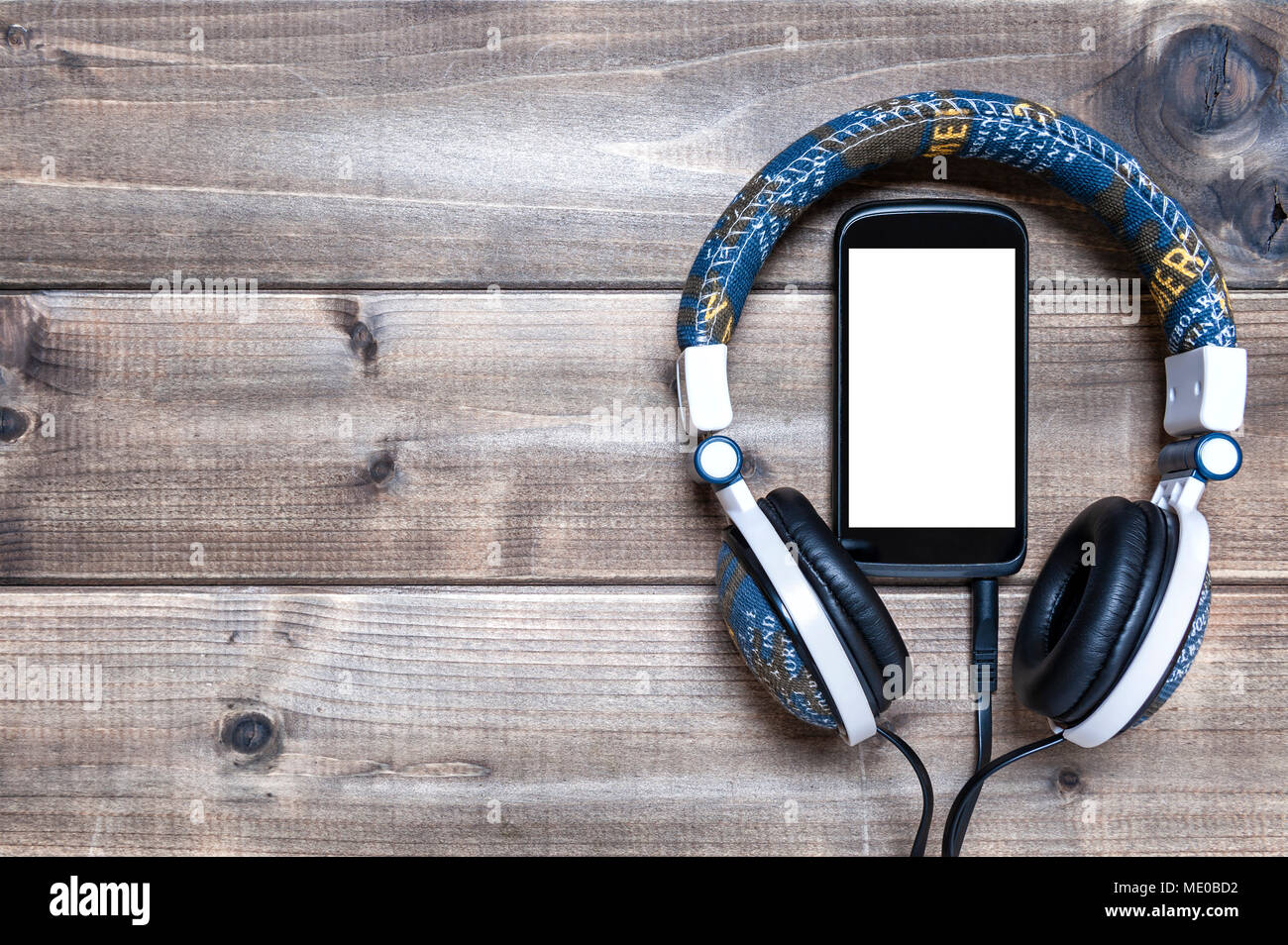 Top view of a smartphone and an audio headphone clad in jeans fabric ...
