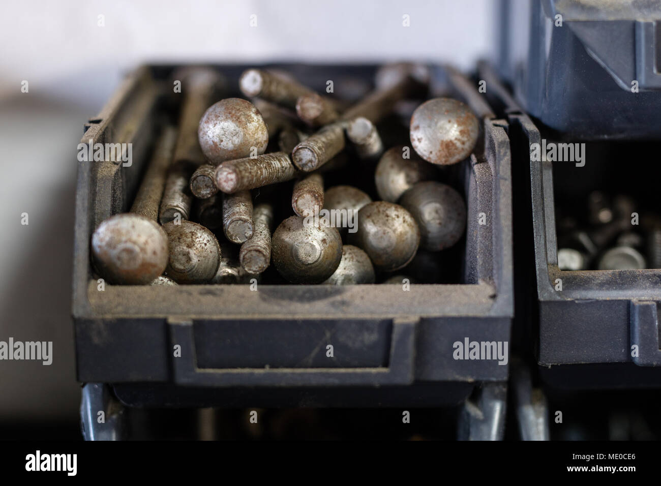 Metal screws in storage containers. Shelf locksmith workshop with parts ...