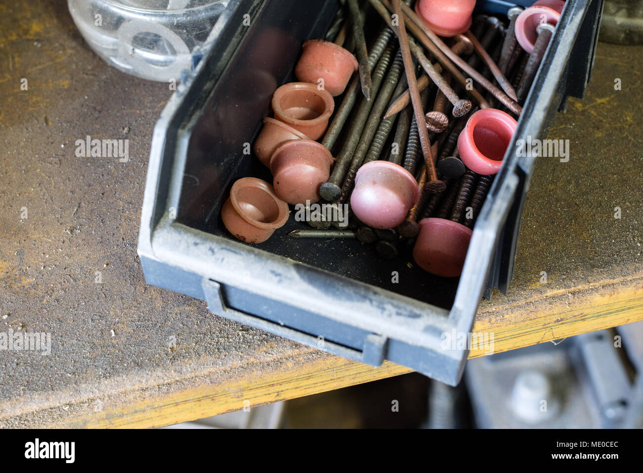 Metal screws in storage containers. Shelf locksmith workshop with parts ...