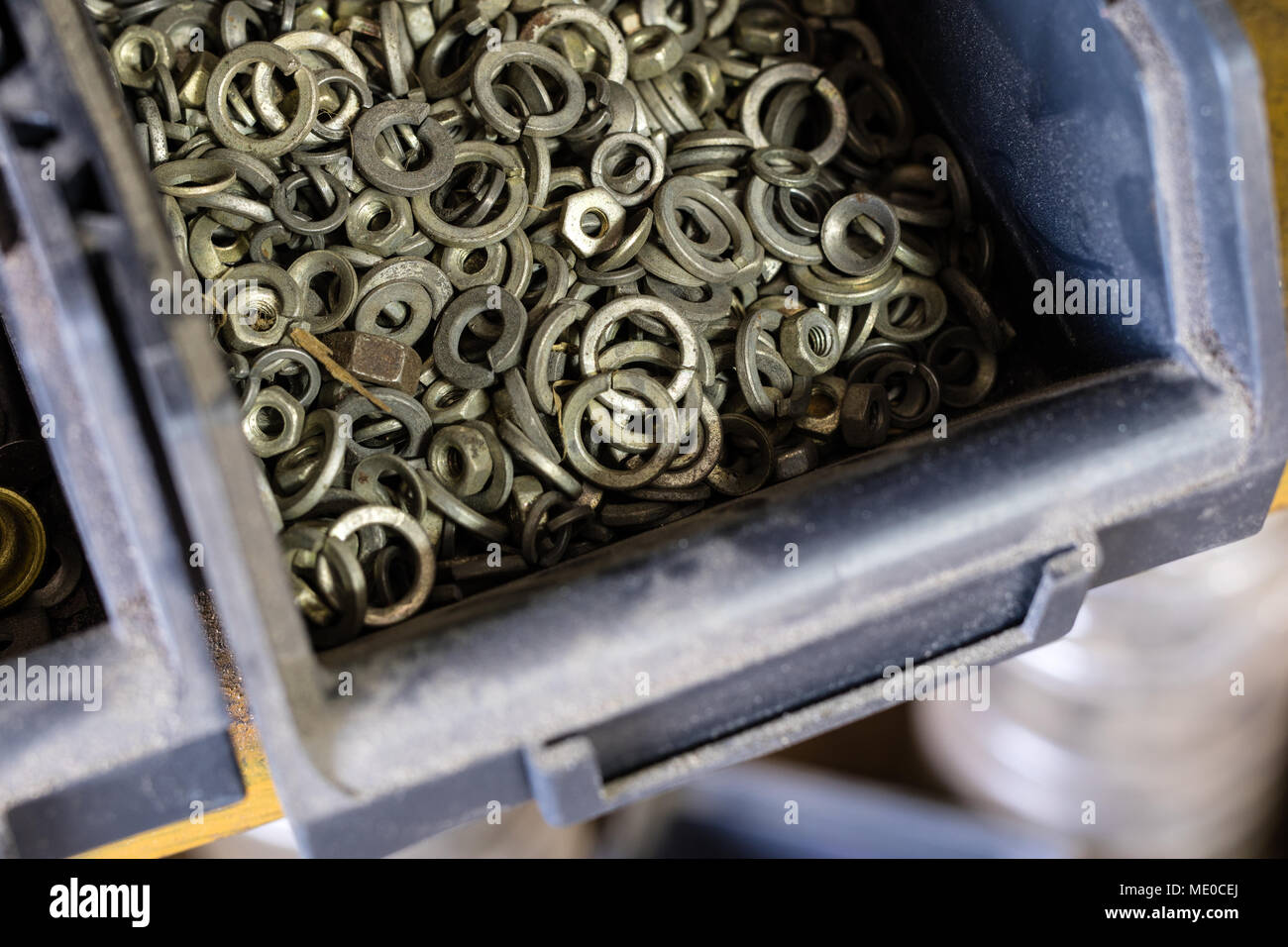 Metal screws in storage containers. Shelf locksmith workshop with parts ...