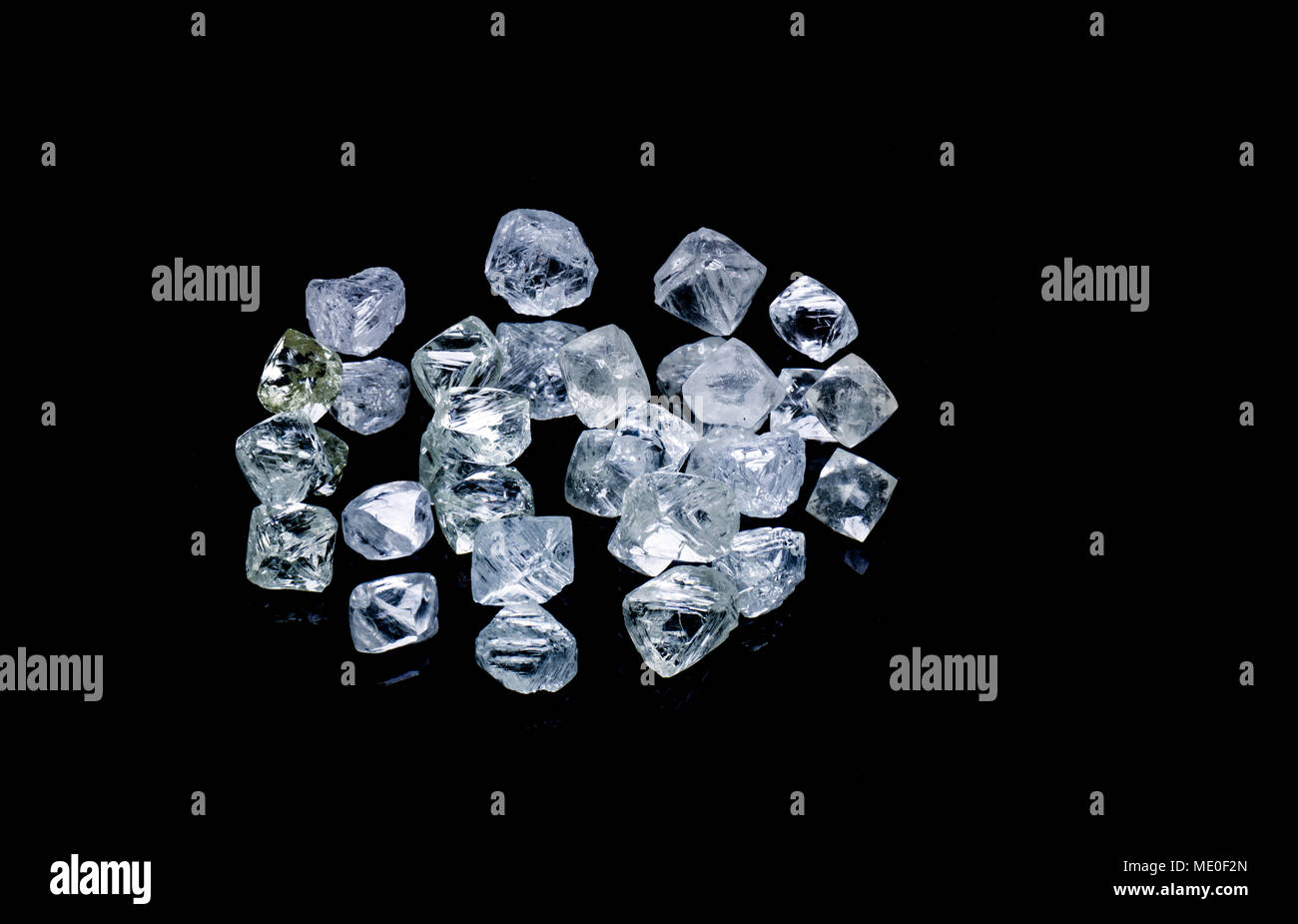 Raw diamonds isolated on black background Stock Photo - Alamy