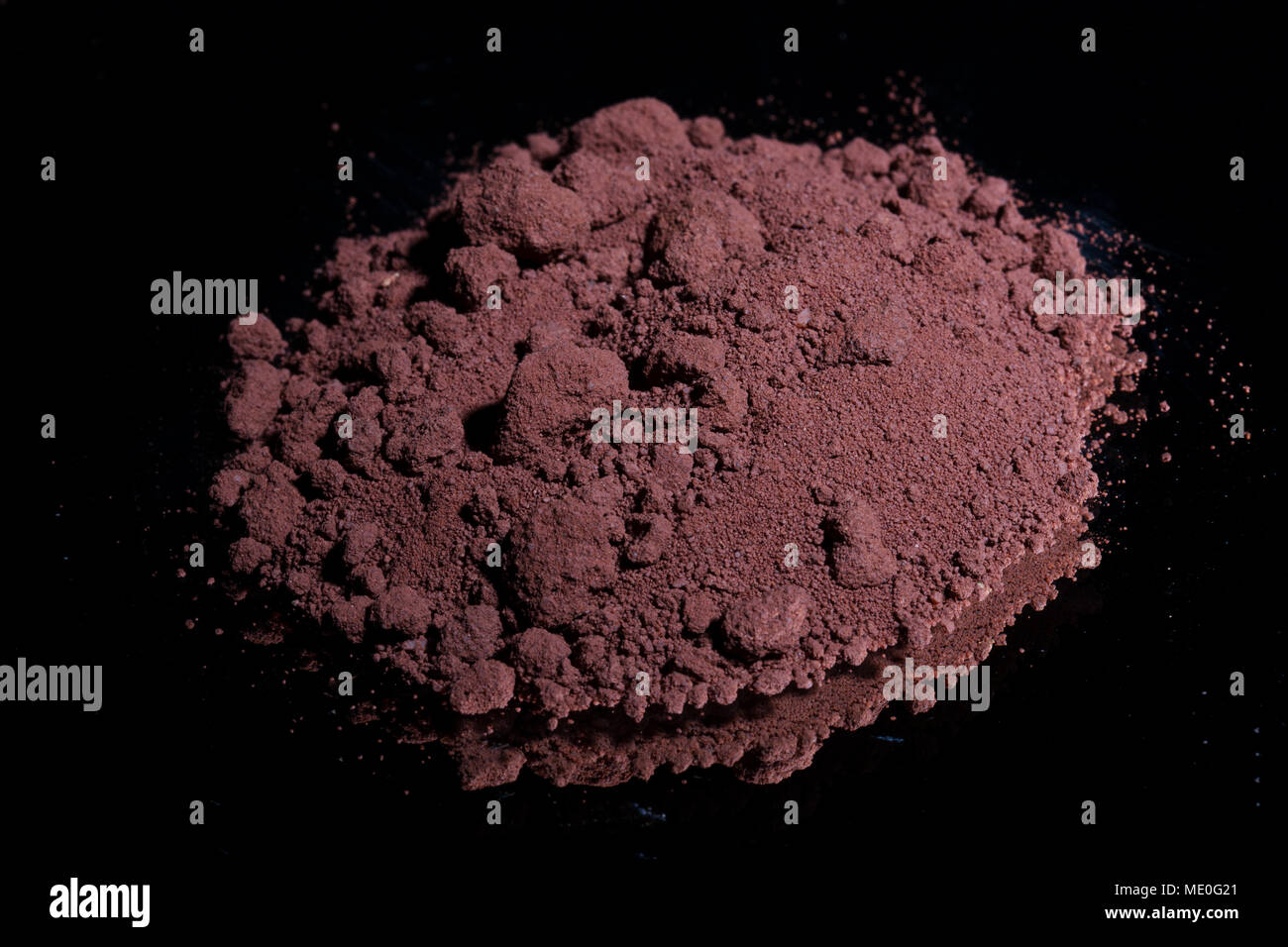 Ore from a diamond mine. isolated on black background with reflexion ...